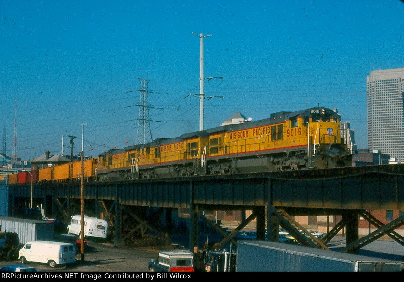 MP C36-7's pull empty hoppers up the west approach to McArthur Bridge on the way back to the ...
